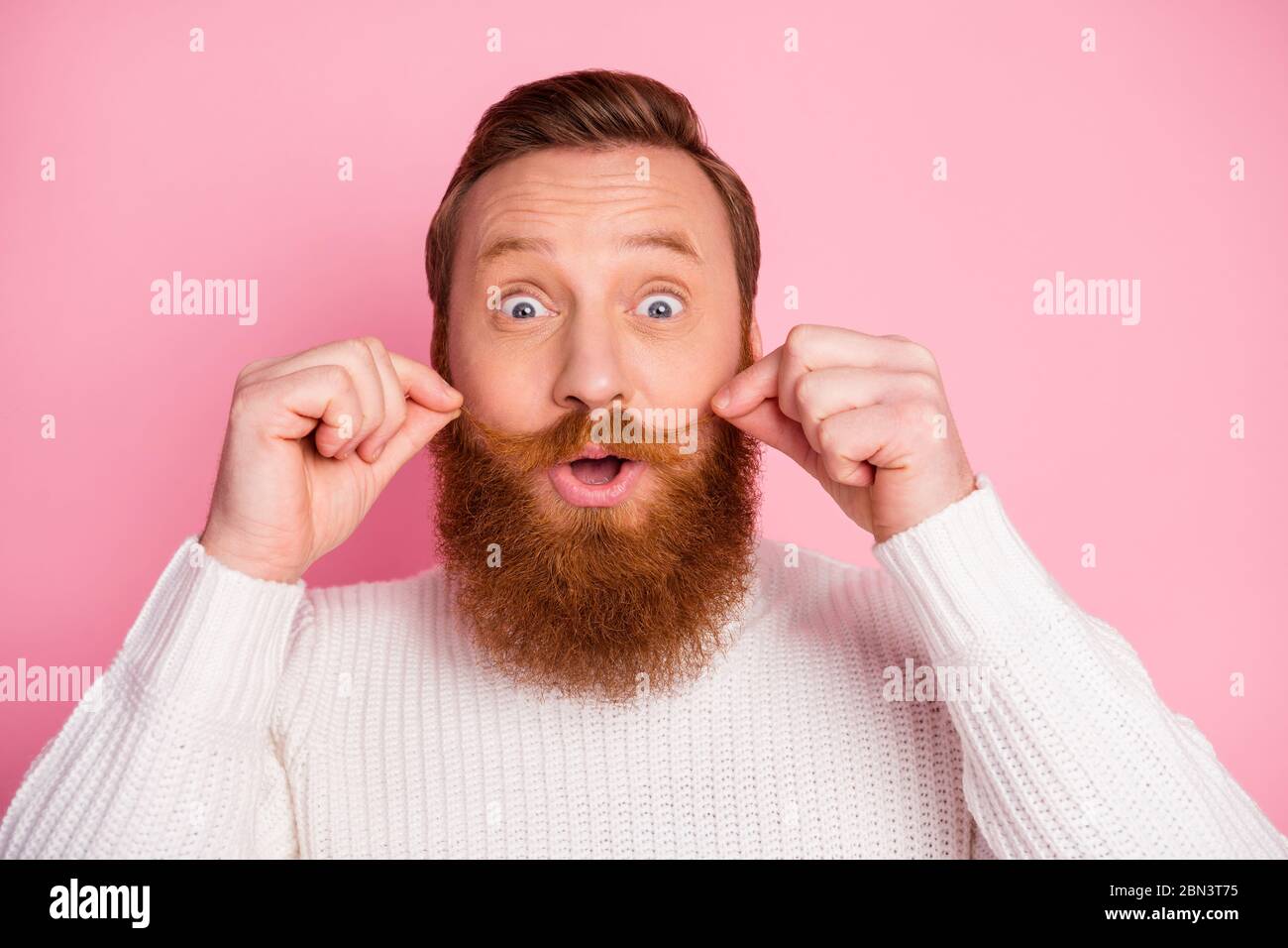 Attractive happy man fixing moustache hi-res stock photography and images - Alamy