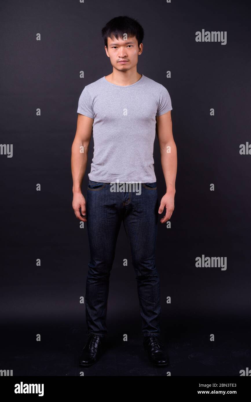 Portrait of young Asian man looking at camera Stock Photo - Alamy