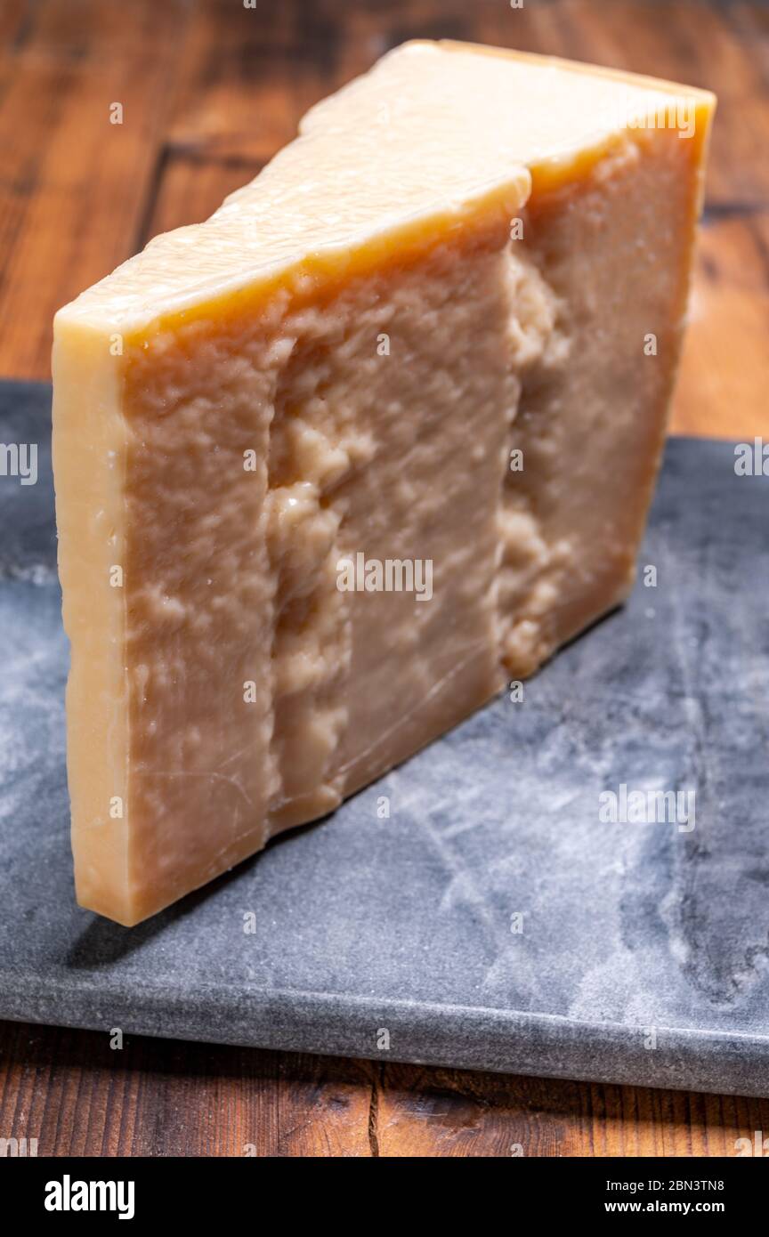 Big wedge of parmigiano-reggiano parmesan hard Italian cheese made from ...