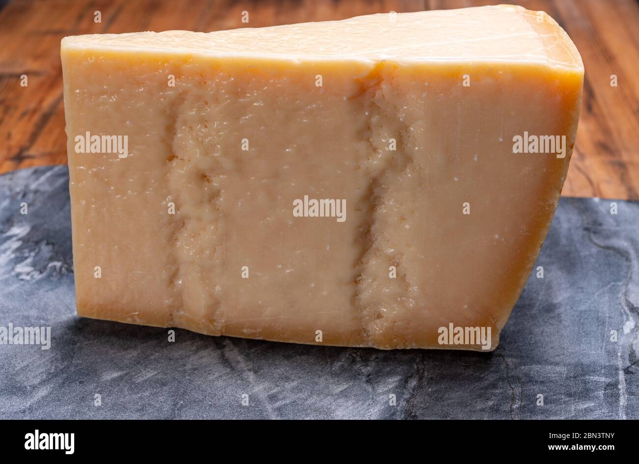 Big wedge of parmigiano-reggiano parmesan hard Italian cheese made from ...