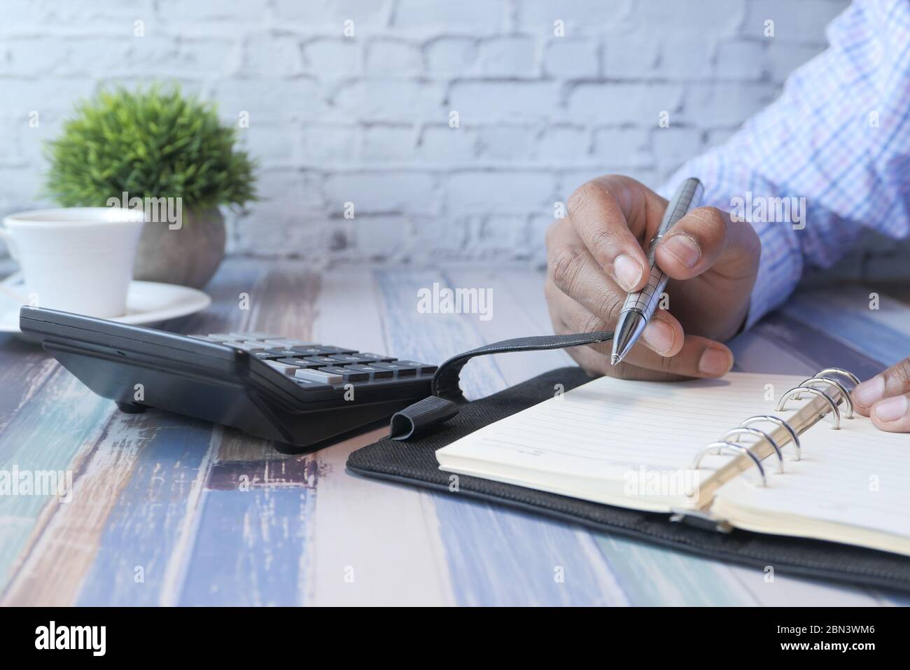 Close up of person hand writing on notepad Stock Photo - Alamy