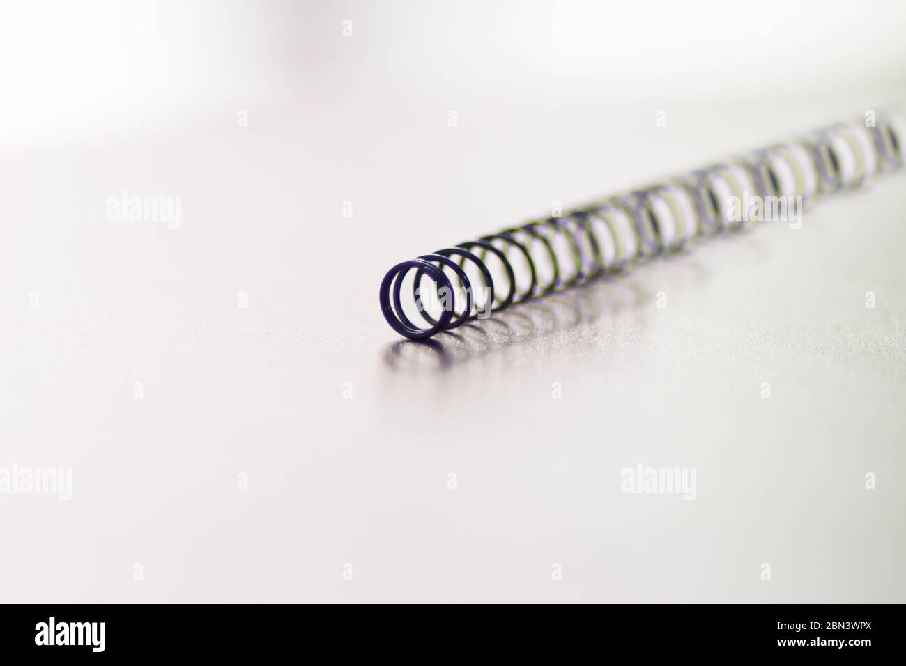 Small wire spring of a ballpoint pen. No people Stock Photo - Alamy