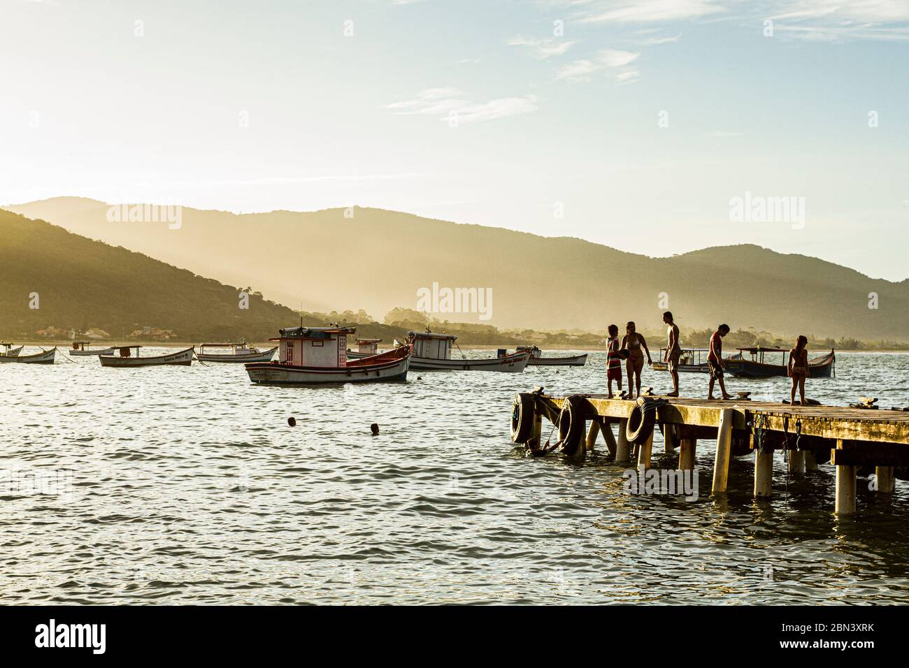 People on a pier at Armacao Beach. Florianopolis, Santa Catarina ...