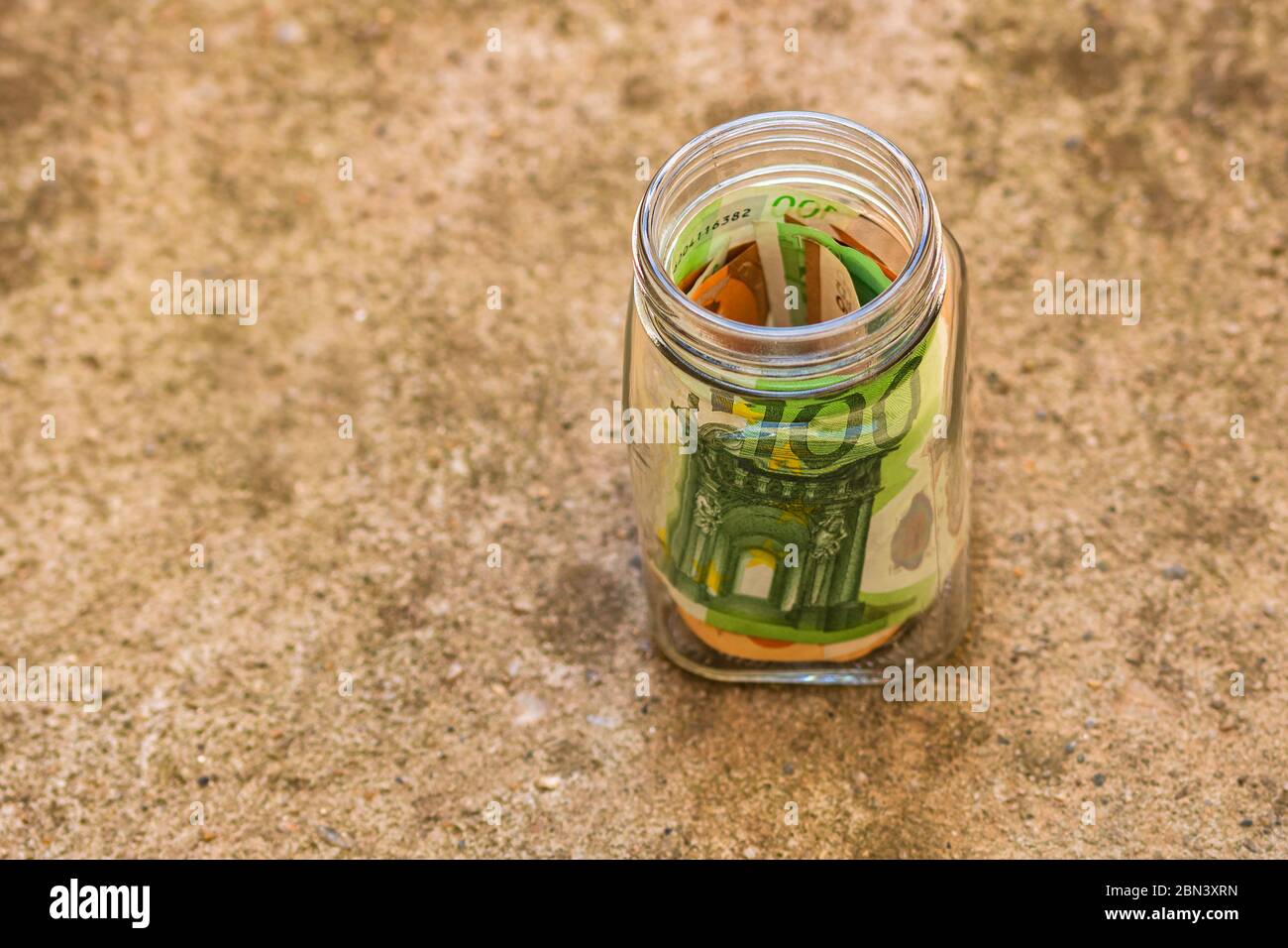 Composition with saving money banknotes in a glass jar. Concept of ...
