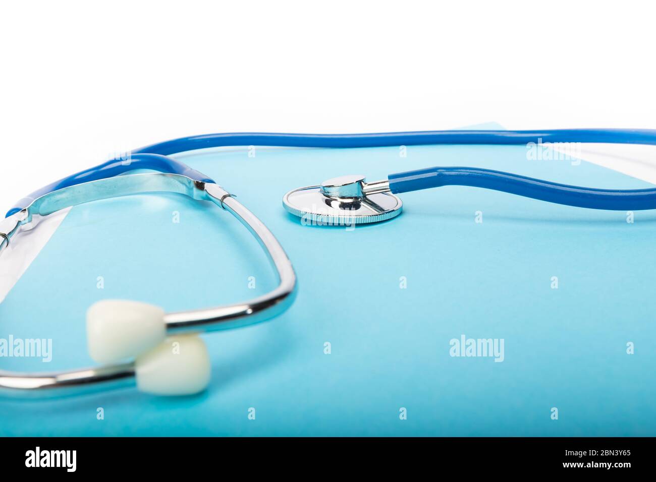 medical record and blue stethoscope close-up on white background in ...