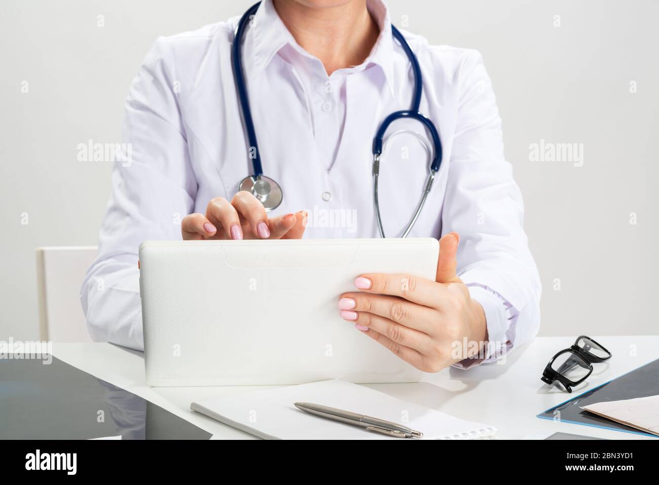 Close up female doctor hands using tablet computer Stock Photo - Alamy