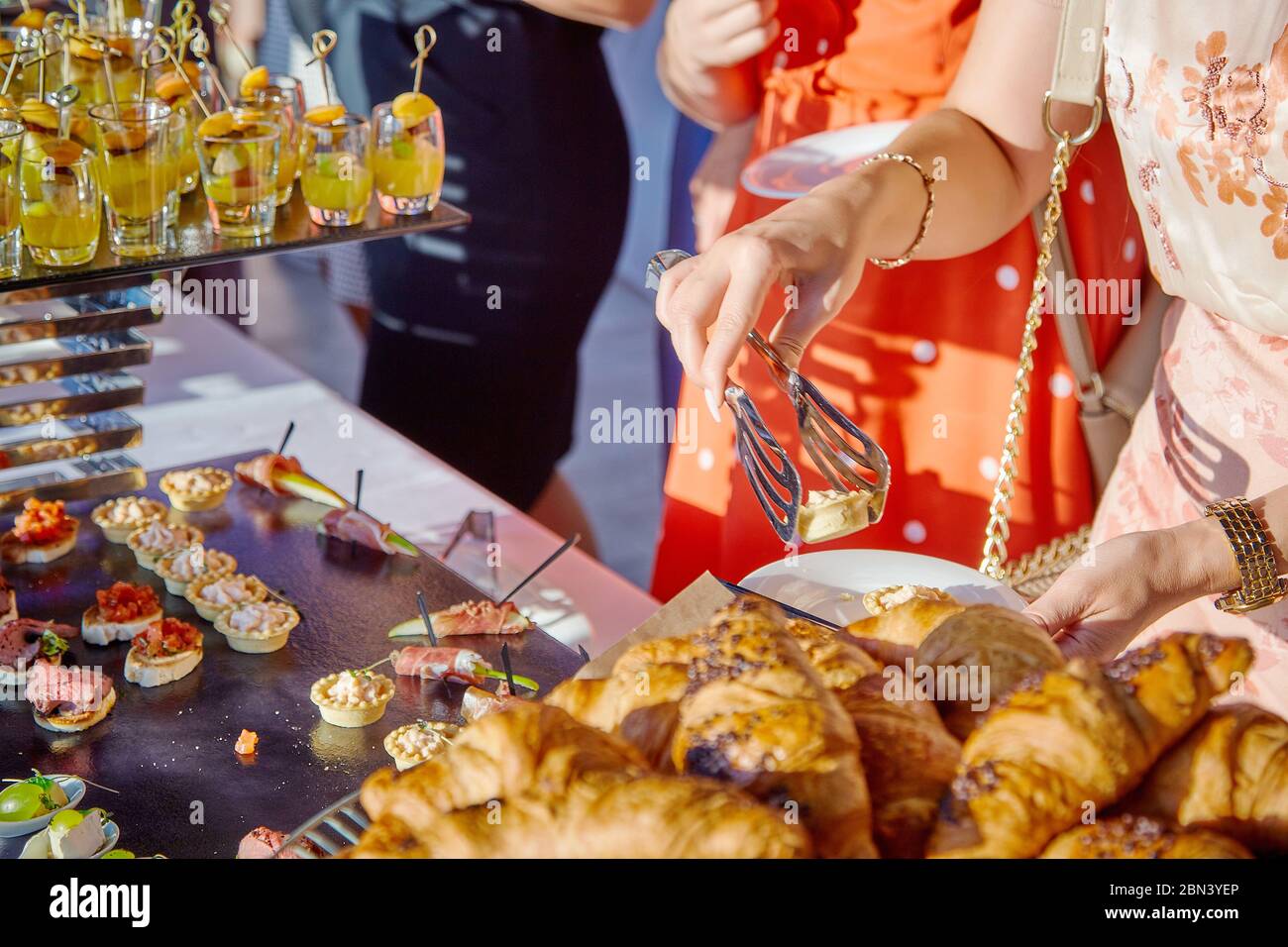 Female hands taking food at a banquet at a conference Stock Photo - Alamy
