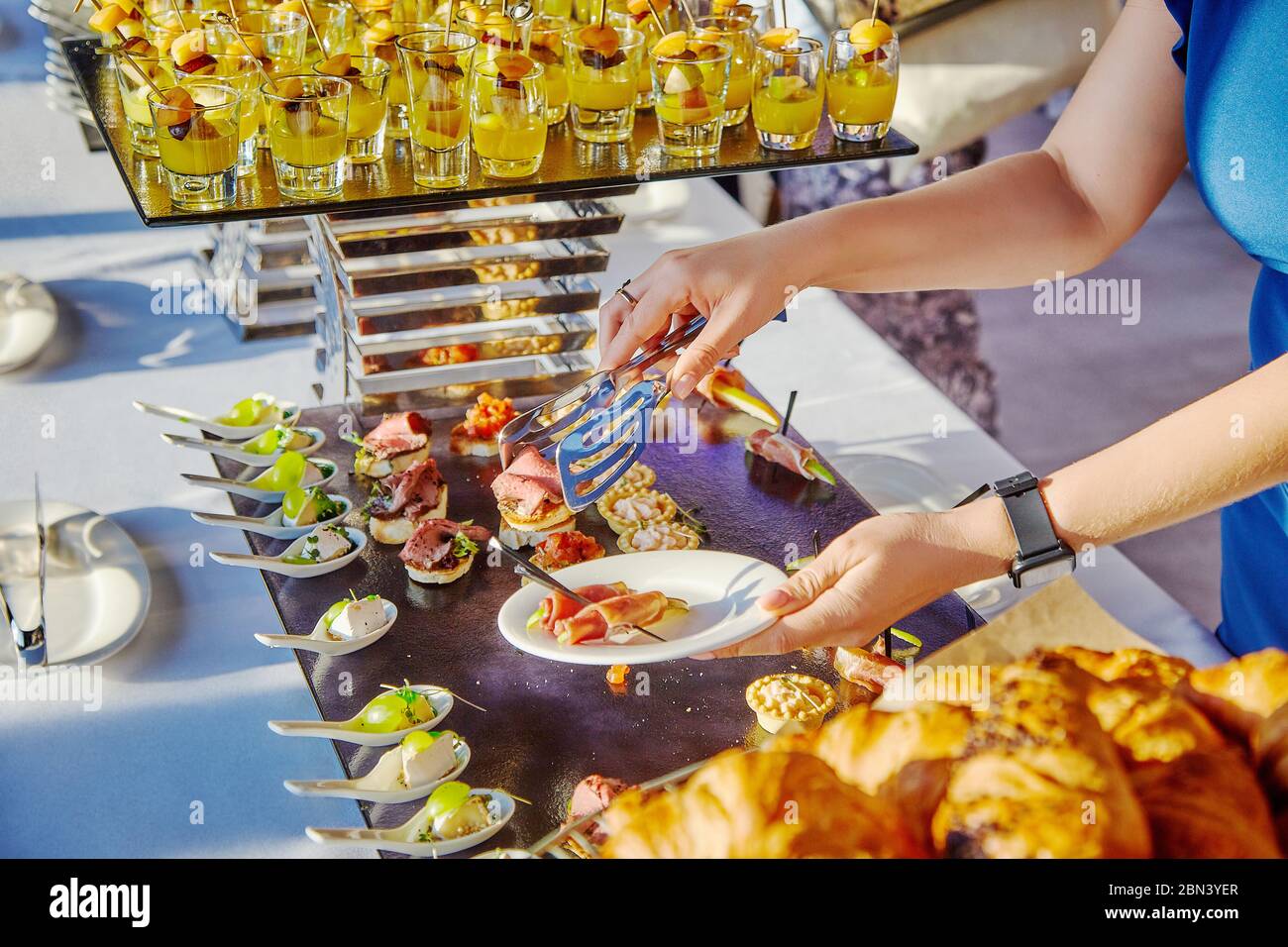 Female hands taking food at a banquet at a conference Stock Photo - Alamy