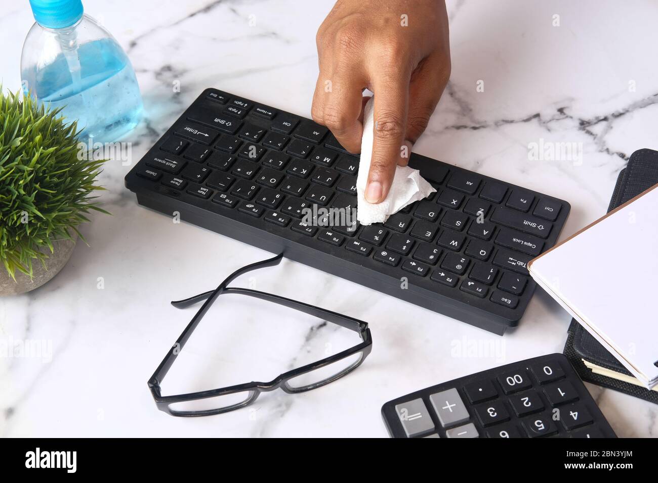 cleaning the keyboard rom dirt and viral germs Keywords Stock Photo - Alamy