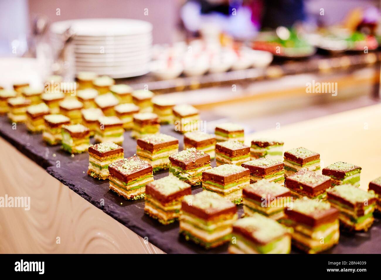 Square pieces of cake lying on trays on a banquet table Stock Photo - Alamy