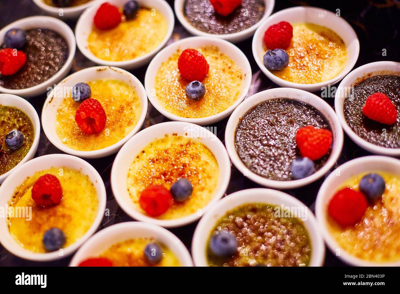 Two types of soufflé in white bowls decorated with raspberries and ...
