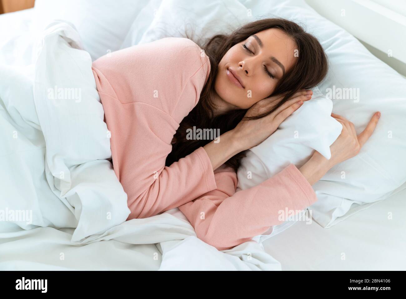 Image of a pretty young woman indoors at home lies in bedroom in bed sleeping Stock Photo - Alamy