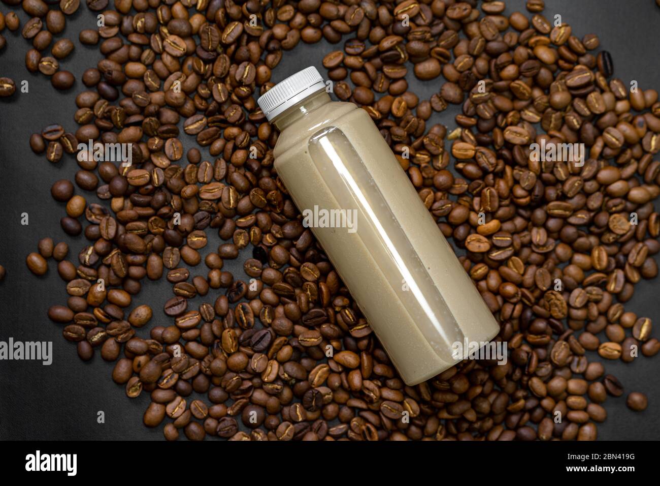 Bottled milk coffee is placed on roasted coffee beans Stock Photo - Alamy