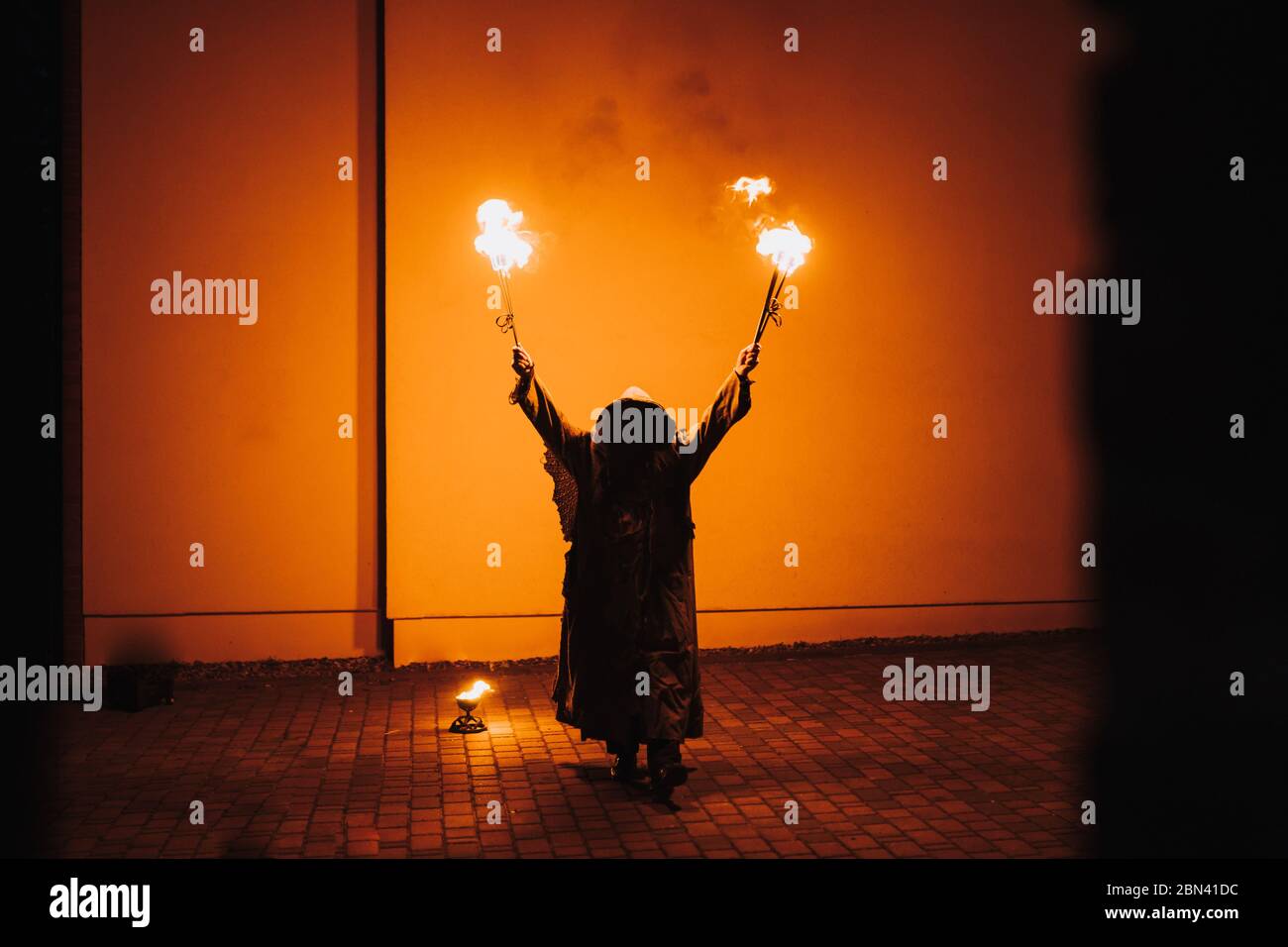 photo of a fire show performer playing with fire Stock Photo - Alamy