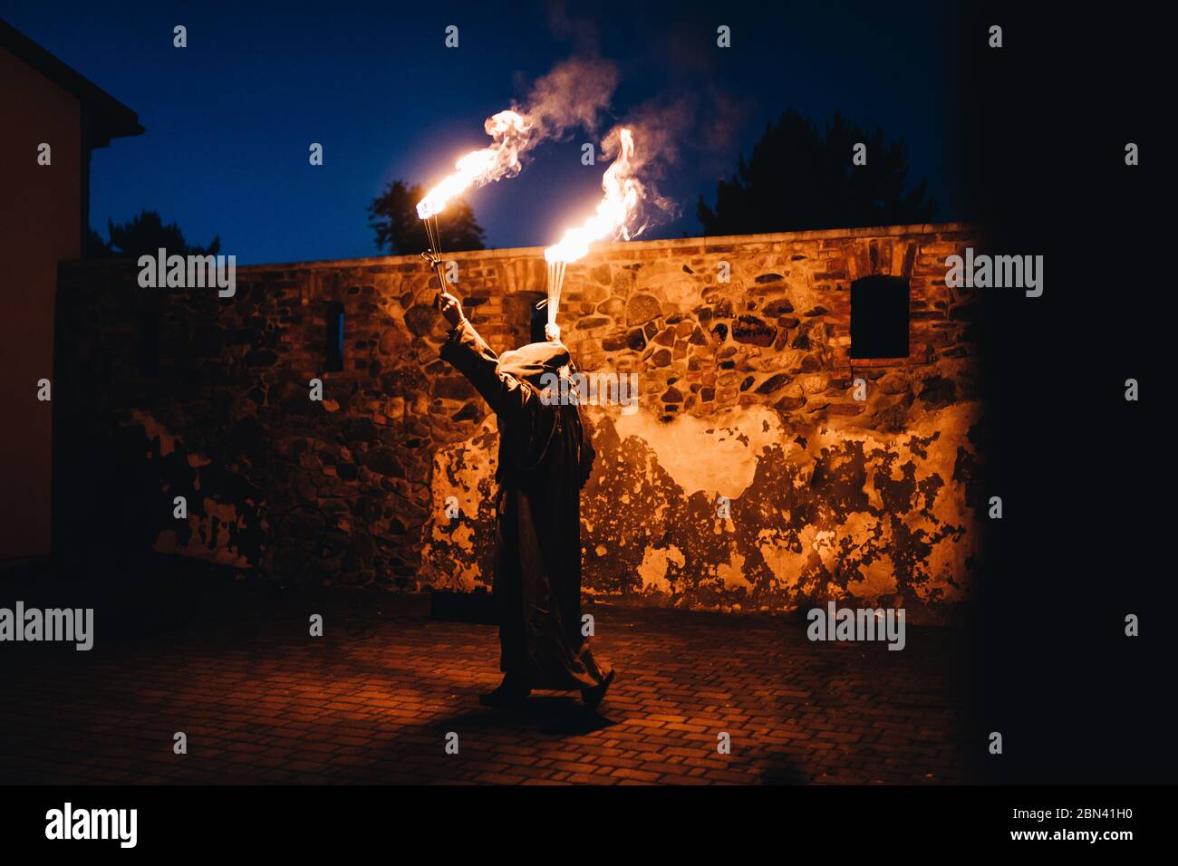 photo of a fire show performer playing with fire Stock Photo - Alamy