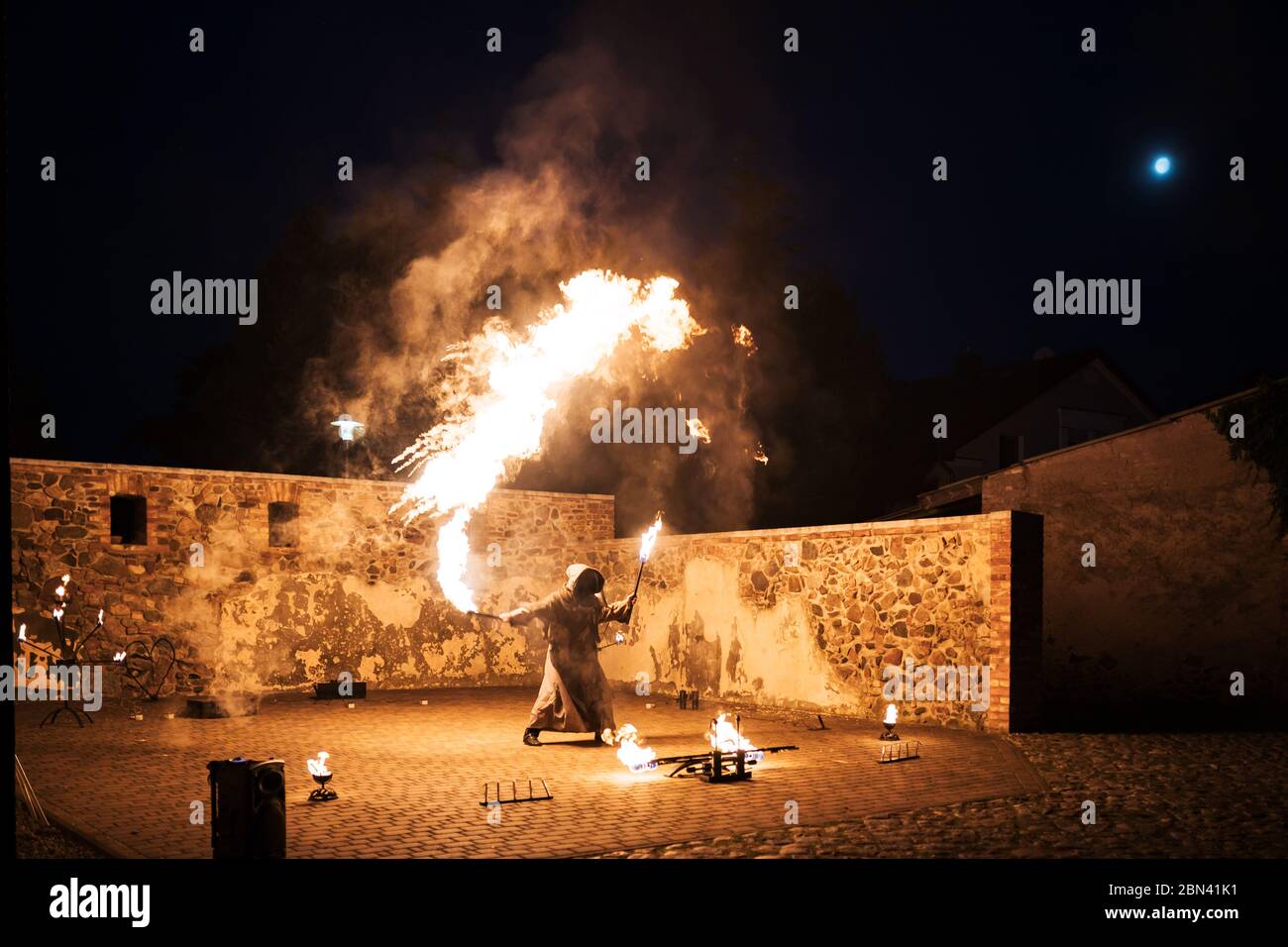 photo of a fire show performer playing with fire Stock Photo - Alamy