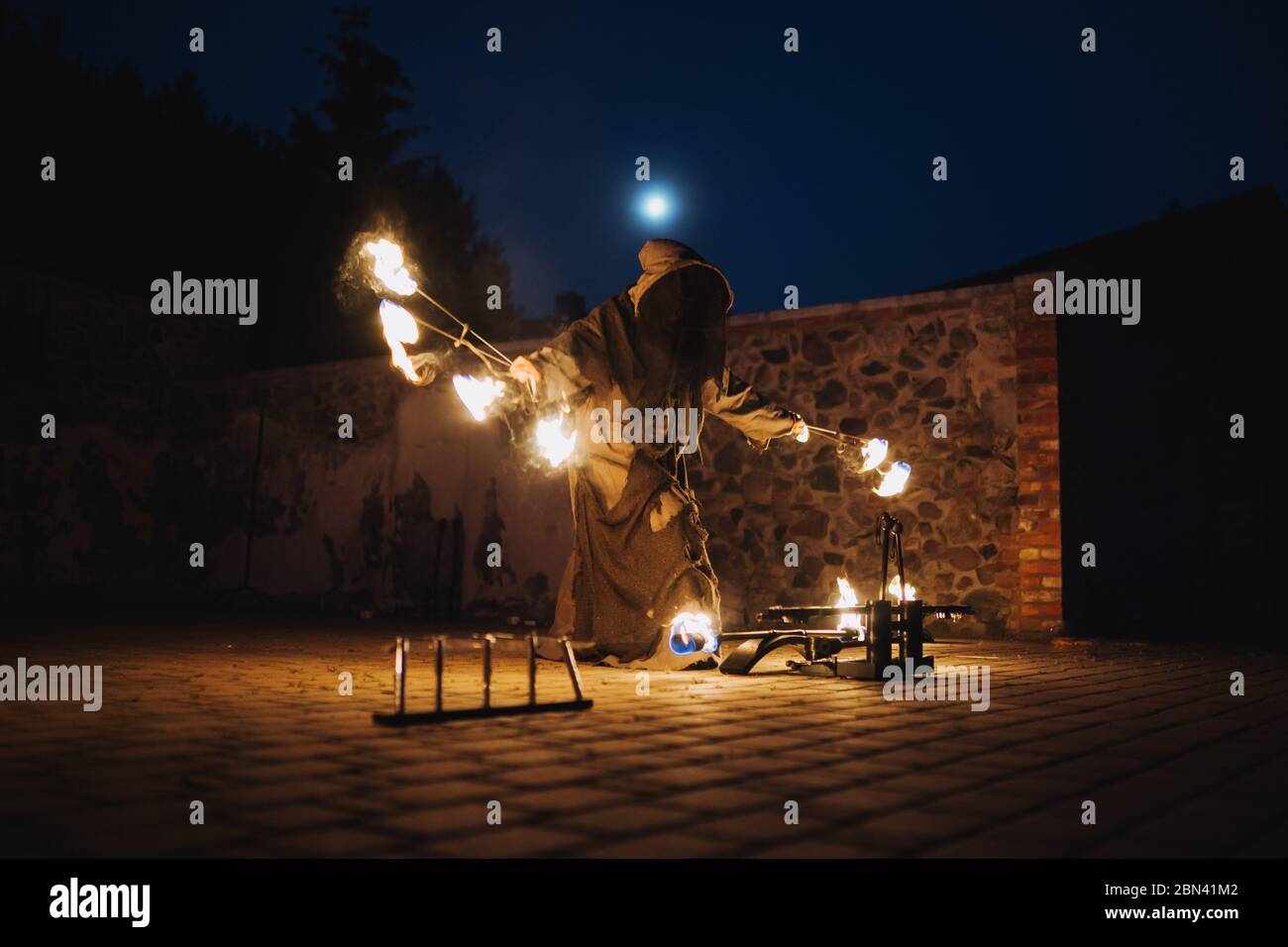 photo of a fire show performer playing with fire Stock Photo - Alamy