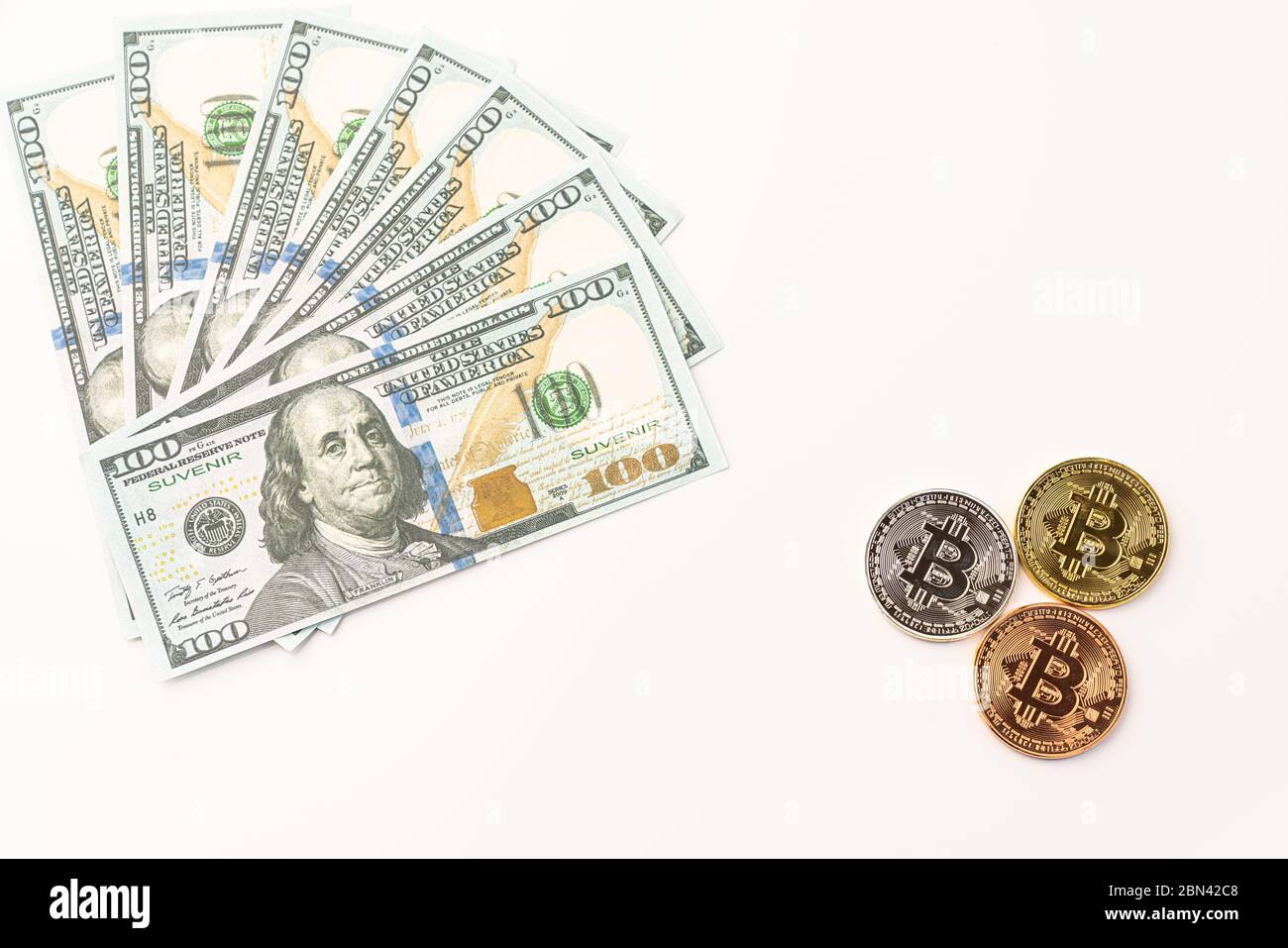 Gold Bit Coin BTC coins and bills of 100 dollars. Worldwide virtual ...