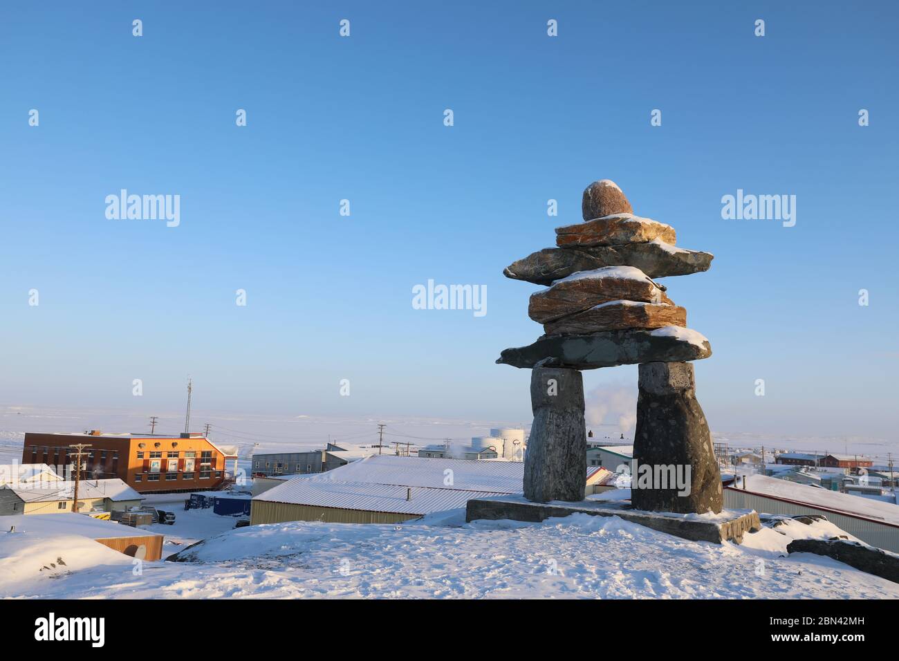 Single Inuksuk or Inukshuk landmark covered in snow on the top of the ...