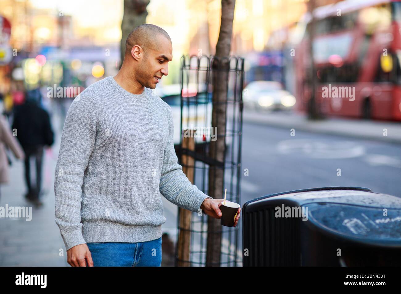 Man throwing rubbish in bin hi-res stock photography and images - Alamy