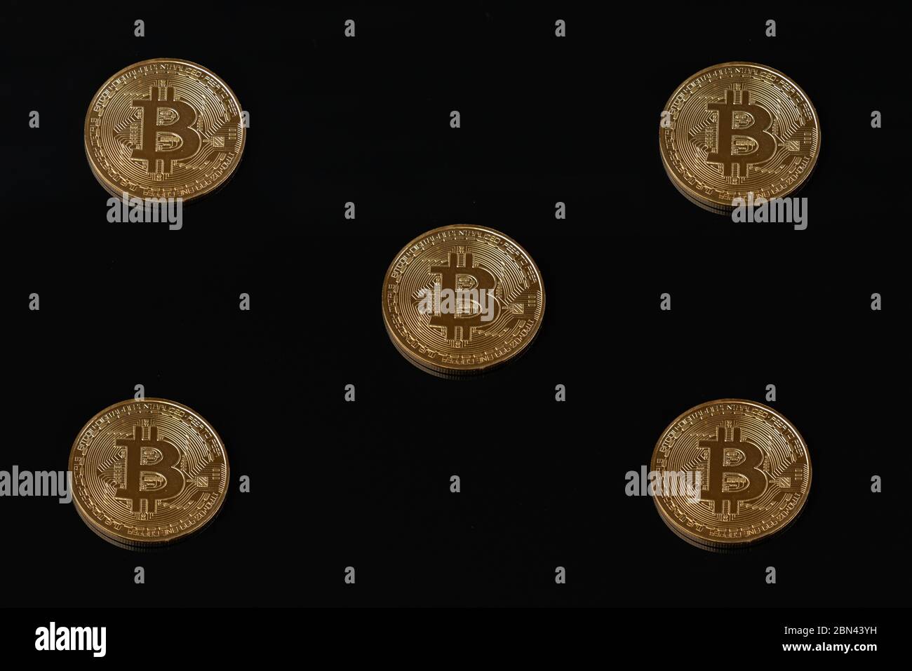 Composition of five golden bitcoin coins isolated on black background ...