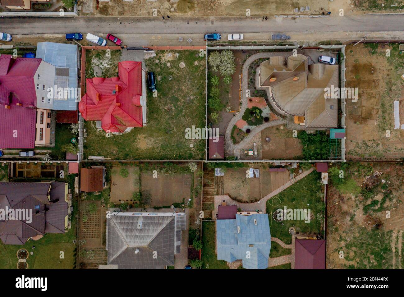 Aerial top view of a house with paved yard with green grass lawn with ...