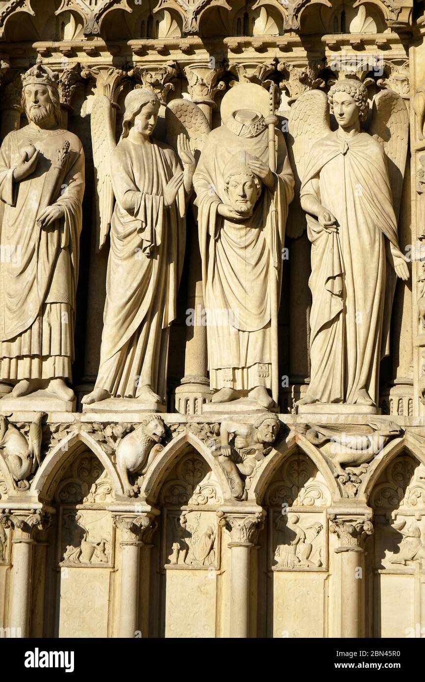Stone carved saints statue decorated facade of Cathedral of Notre Dame ...