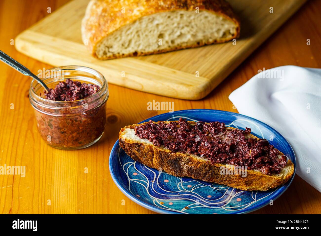 Fresh bread with olive tapenade Stock Photo - Alamy