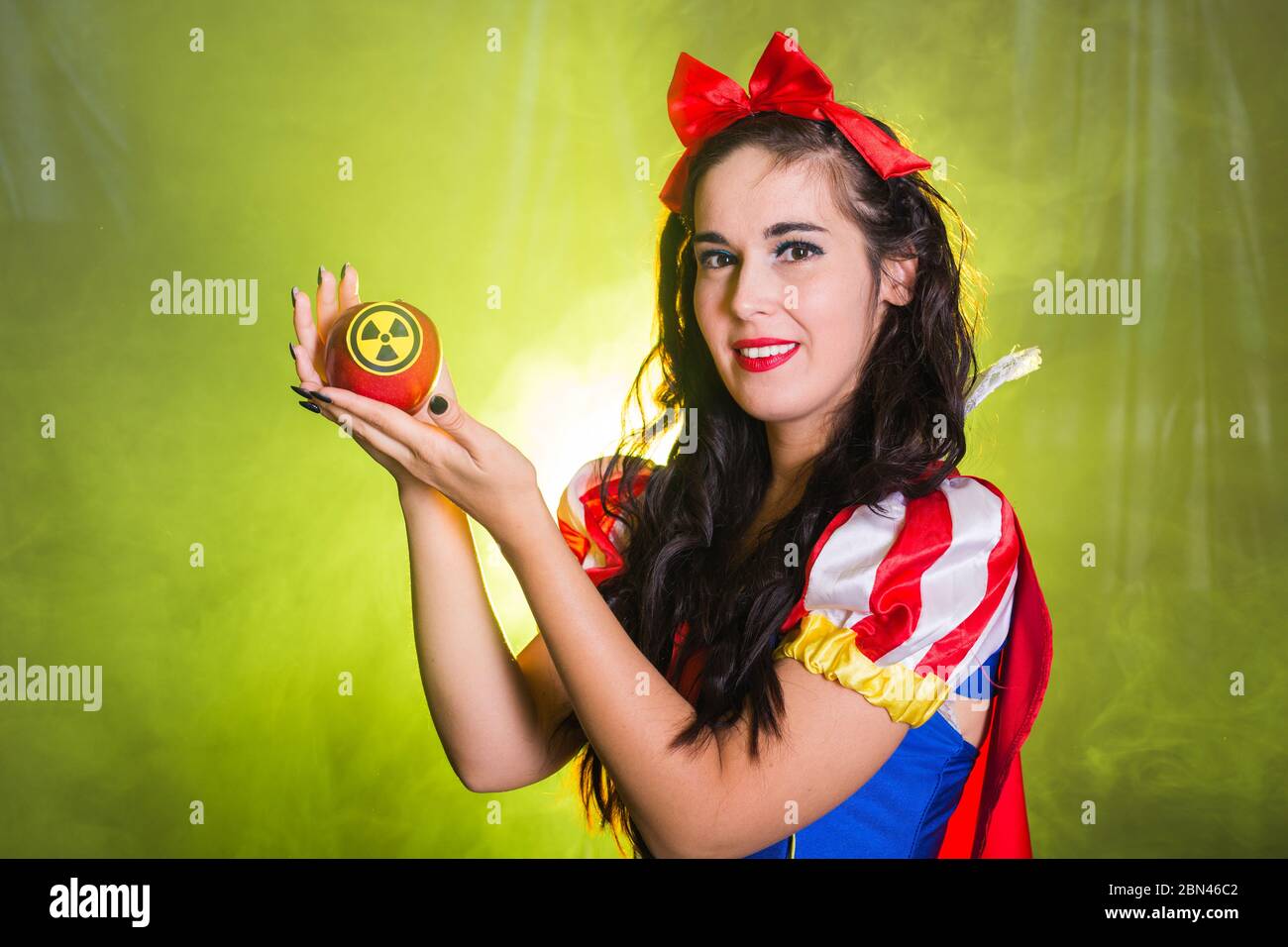 Woman holding hazardous radioactive apple. Nuclear and radiation ...