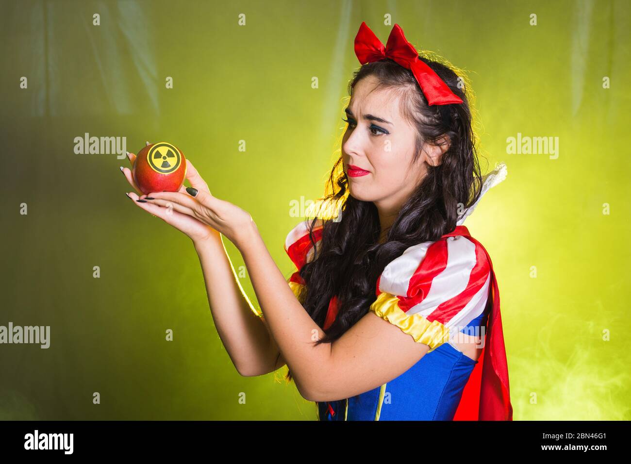 Woman holding hazardous radioactive apple. Nuclear and radiation ...