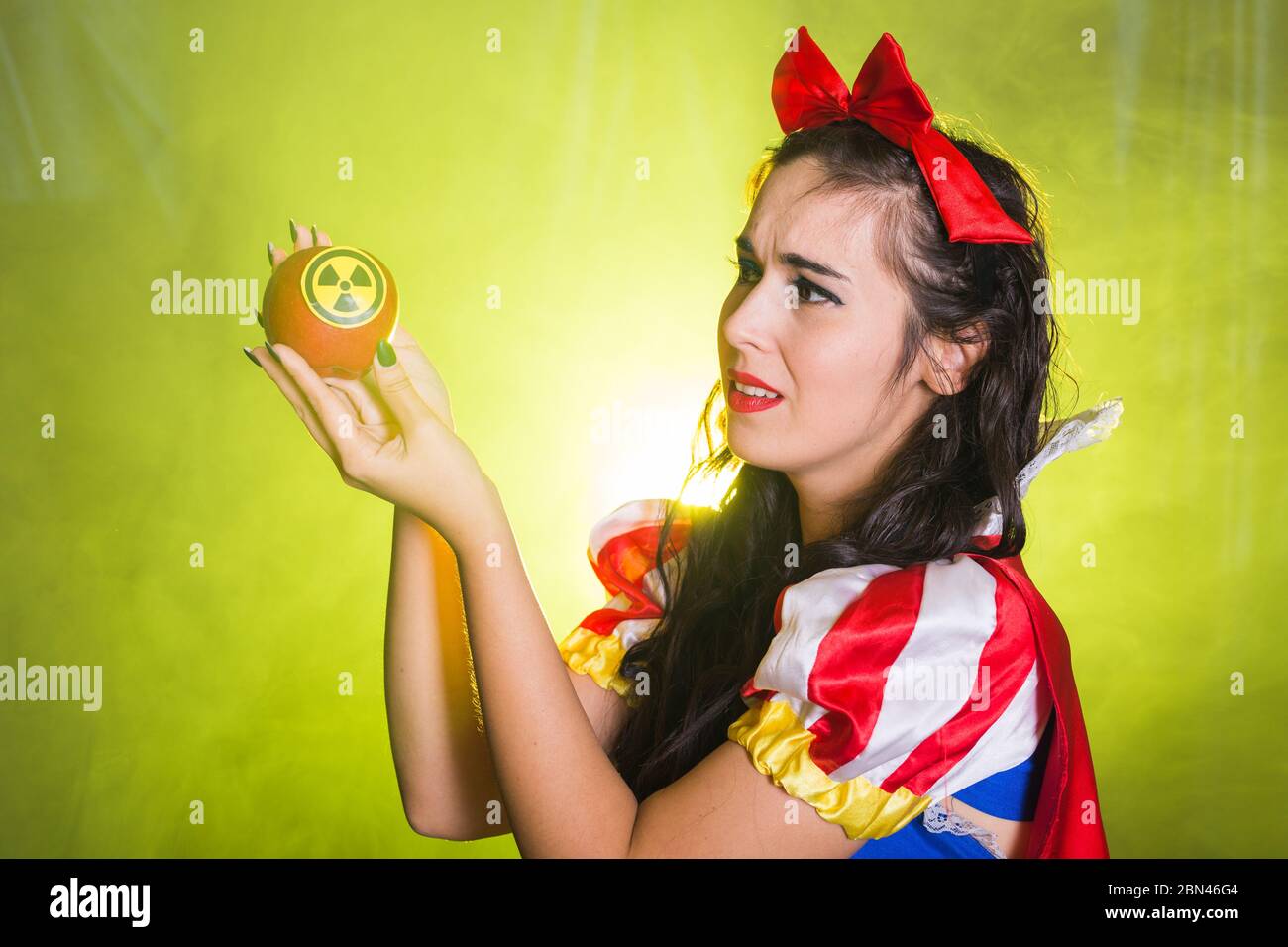 Woman holding hazardous radioactive apple. Nuclear and radiation ...