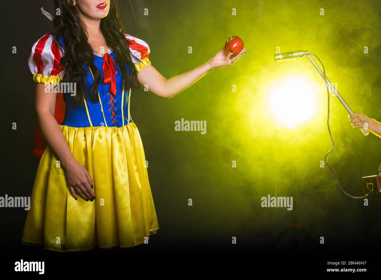 Danger, nuclear and radiation measurement - Girl holds apple with ...