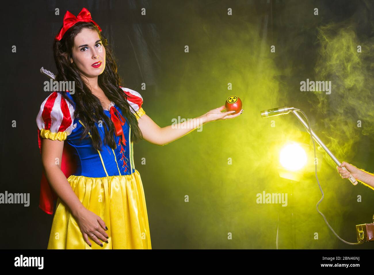 Woman holding hazardous radioactive apple. Nuclear and radiation ...