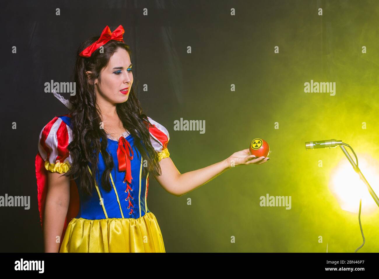 Woman holding hazardous radioactive apple. Nuclear and radiation ...