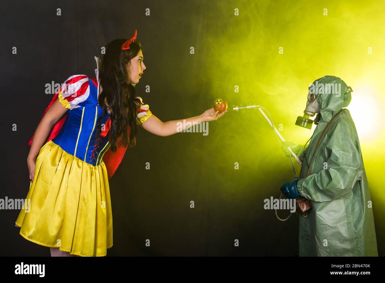 Woman holding hazardous radioactive apple. Nuclear and radiation ...