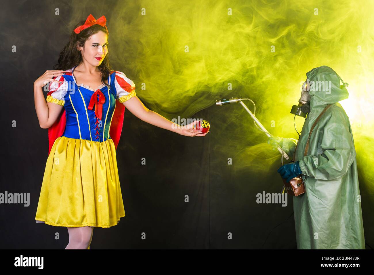 Woman holding hazardous radioactive apple. Nuclear and radiation ...