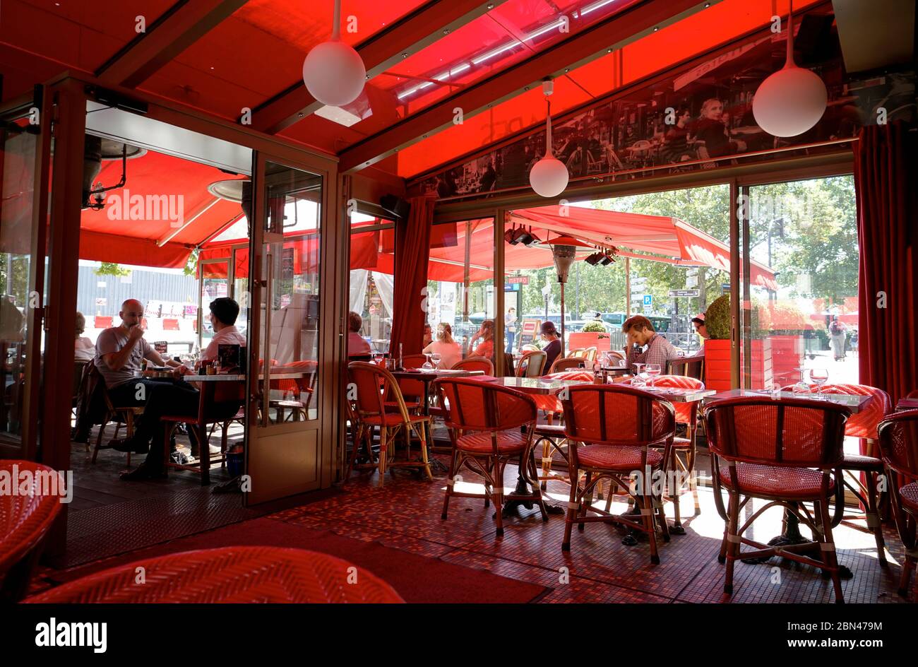 Interior view of a traditional cafe with customers in Place de la ...