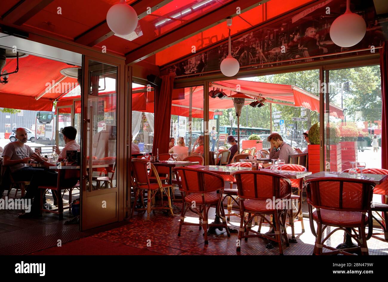 Interior view of a traditional cafe with customers in Place de la ...