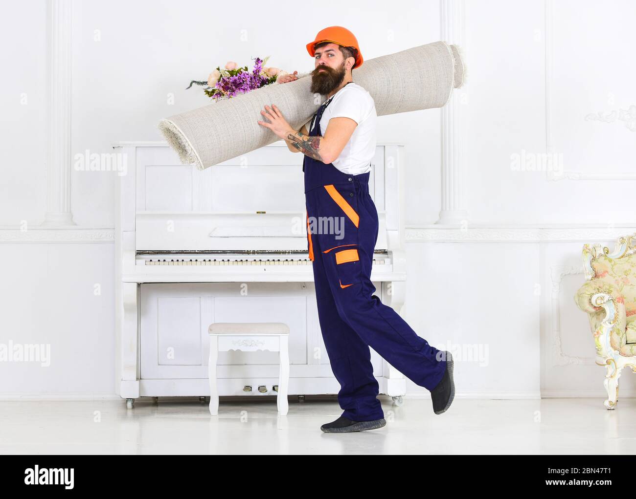 Relocating concept. Man with beard, worker in overalls and helmet ...