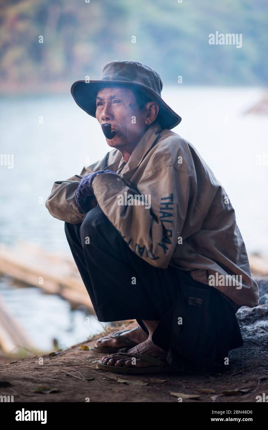 Local Bamboo raft driver smoking a pipe while waiting for costumers at ...
