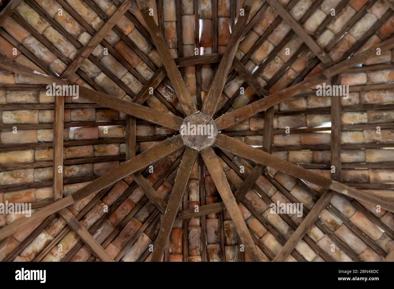 Attic of a bell tower. highlights the exposed wooden beams and the ...
