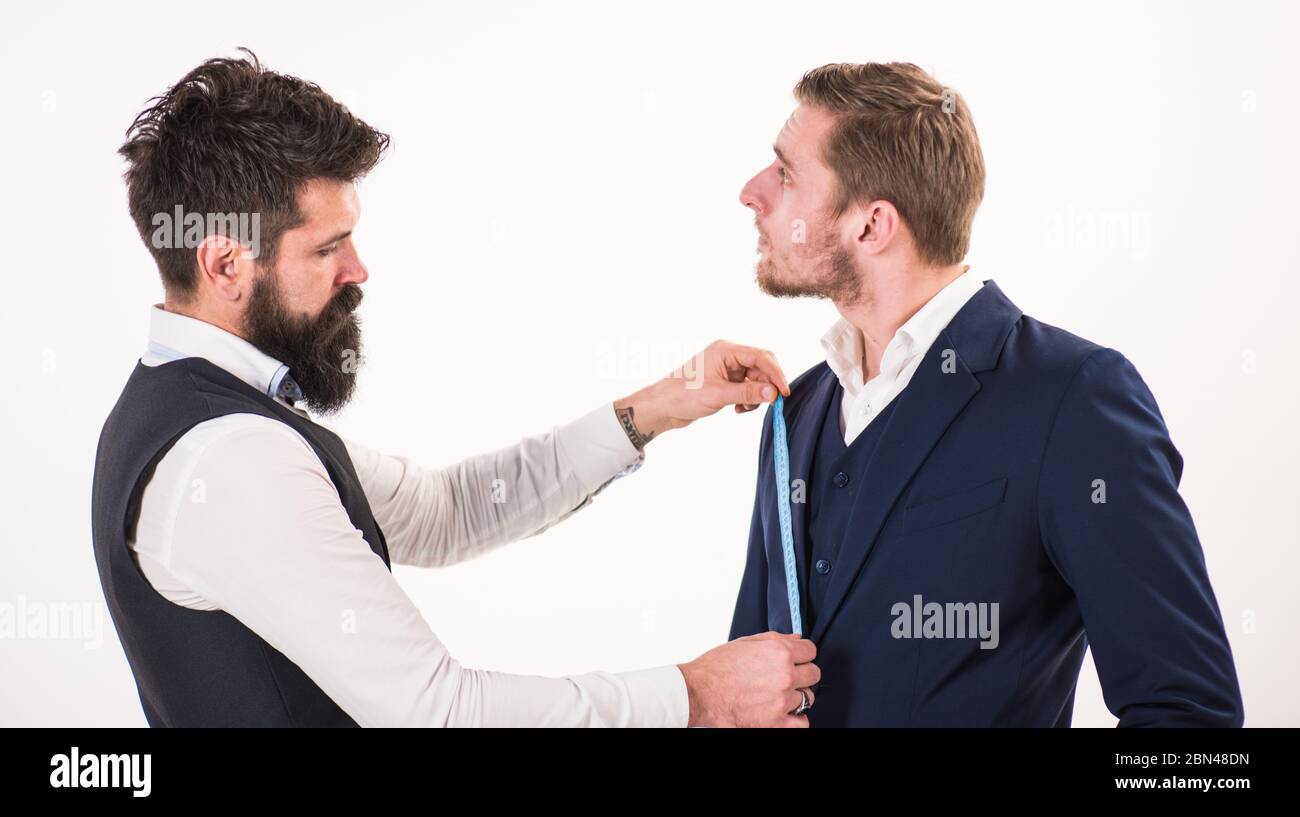 Sewing exclusive clothes concept. Man with beard and mustache holds ...