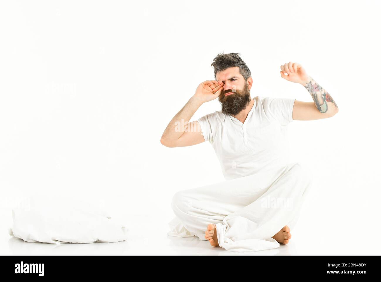 Hipster with beard and mustache stretching arms, sleepyhead. Man with ...