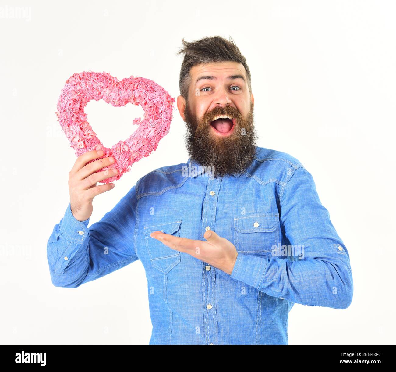 Man with happy face holds pink heart, symbol of love. Man with mustache ...