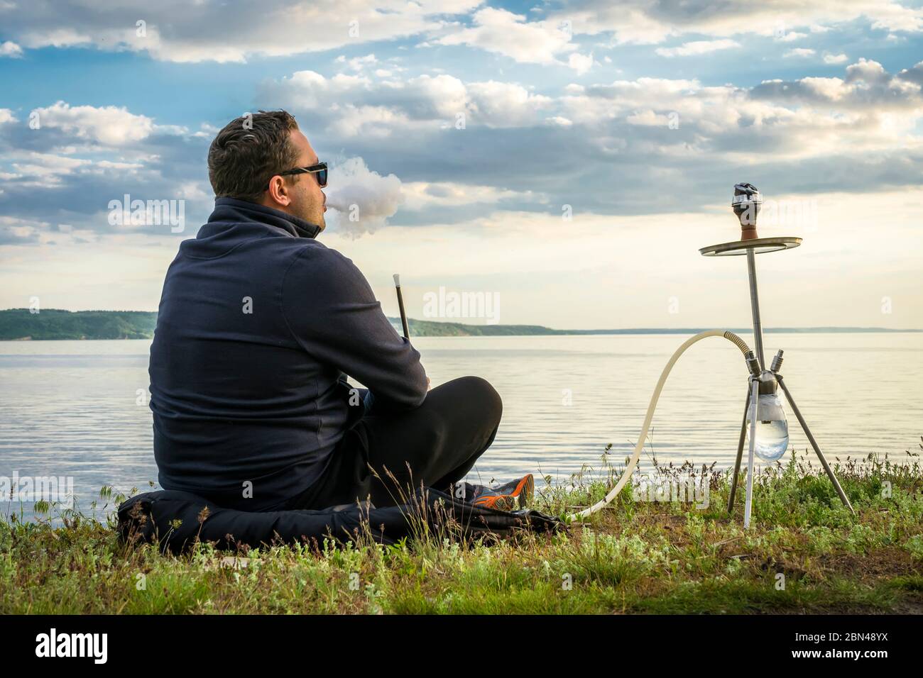 Man smoking hookah and relax outdoor Stock Photo - Alamy
