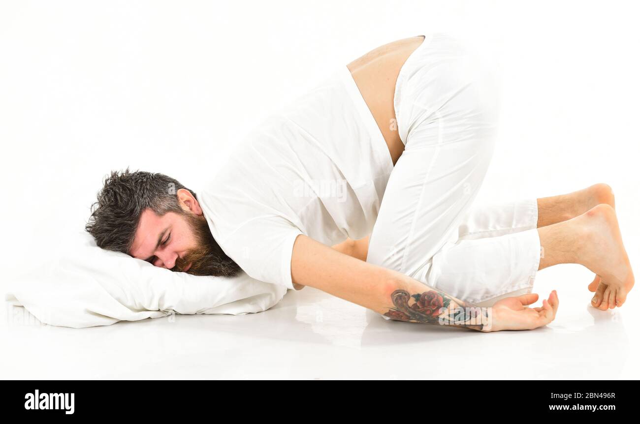 Hipster with sleepy face lies on pillow, sleeps like baby. Sleeps like ...