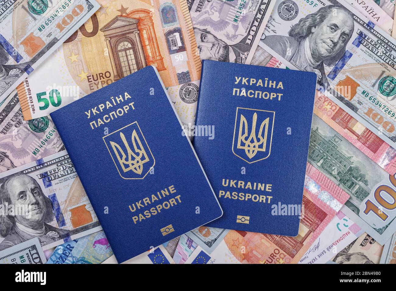 Two Ukrainian Biometric Passports Lie Against A Background Of