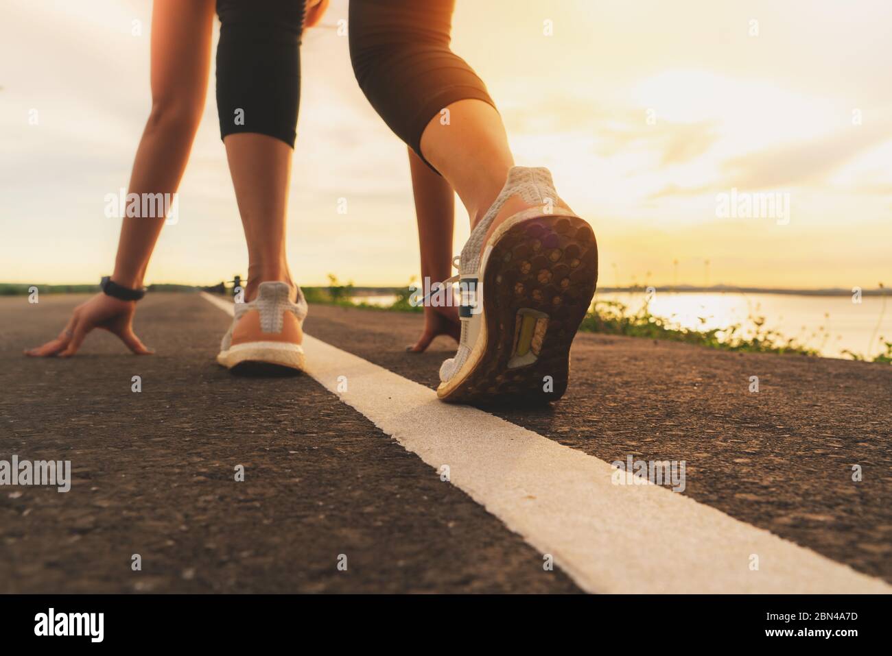 sport runner feet running on sunset lake closeup on shoe Stock Photo ...