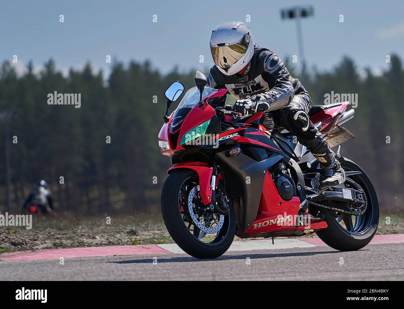 Motorcycle practice leaning into a fast corner on track Stock Photo - Alamy