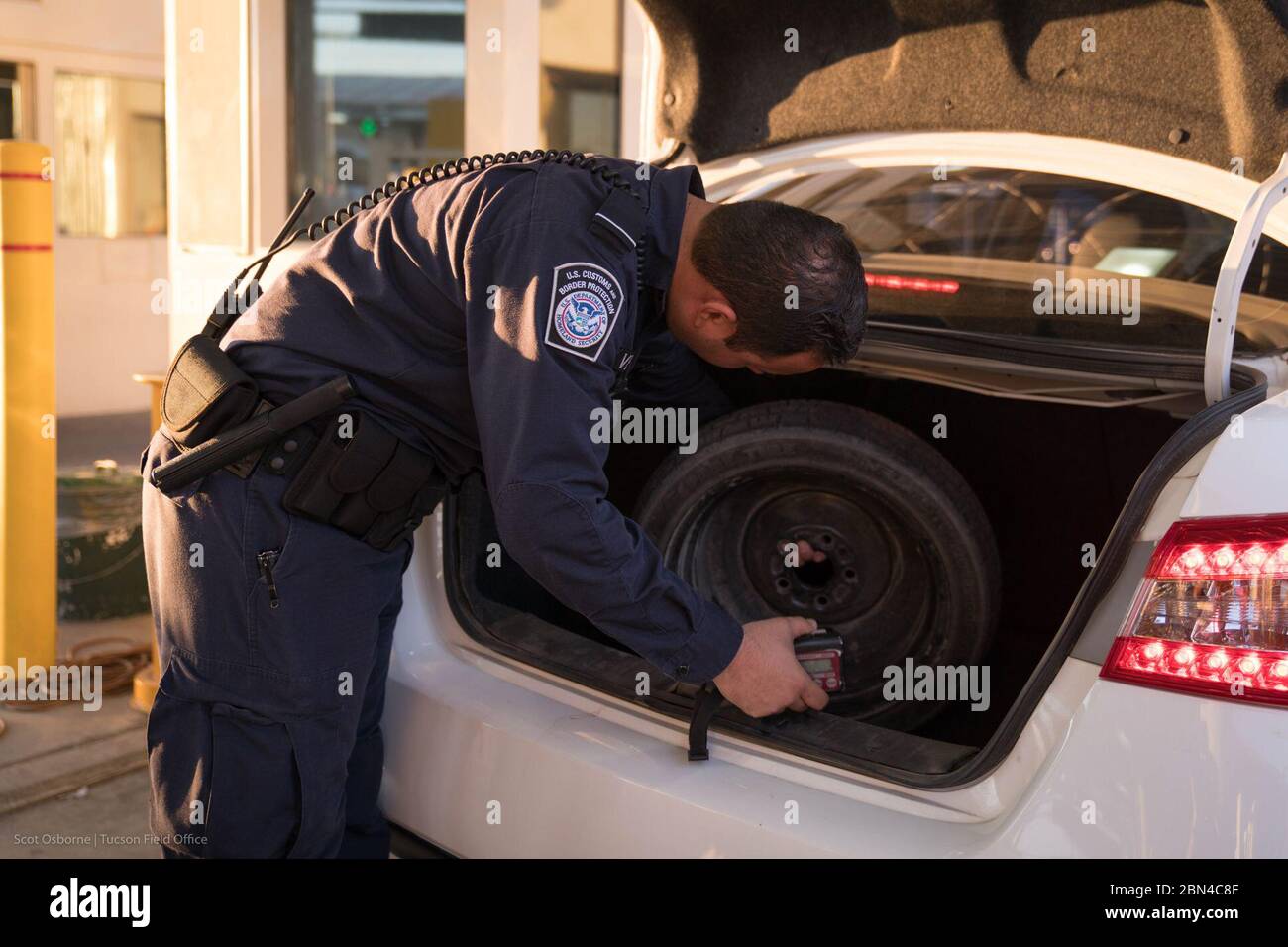 A U.S. Customs and Border Protection officer checks a passenger's ...